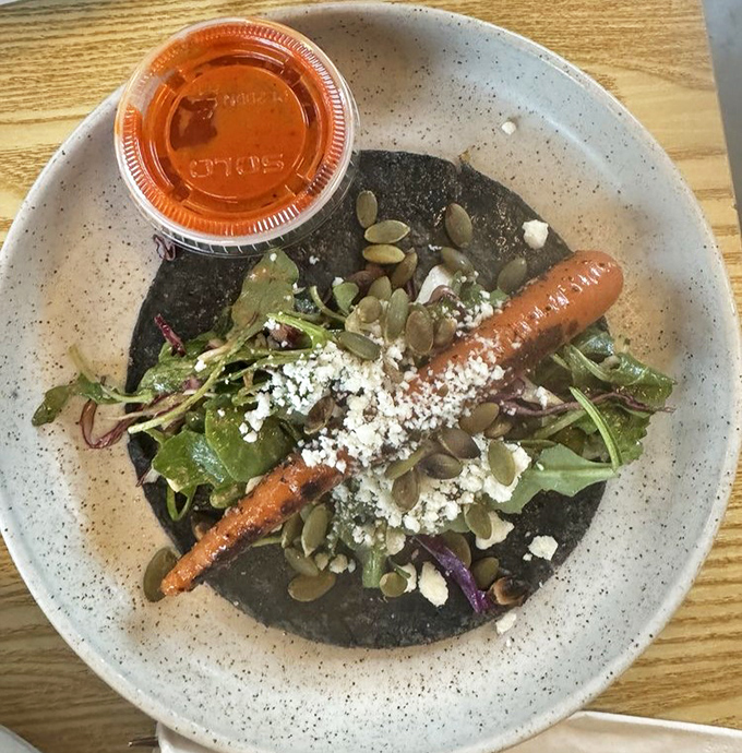 That's not just any carrot taco—it's a vegetable that found its life purpose. The blue corn tortilla is the stage, the carrot is the star.