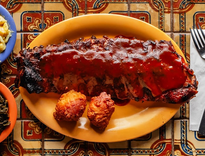 Ribs so tender they practically surrender to your fork. That sauce isn't just red—it's a flavor declaration.