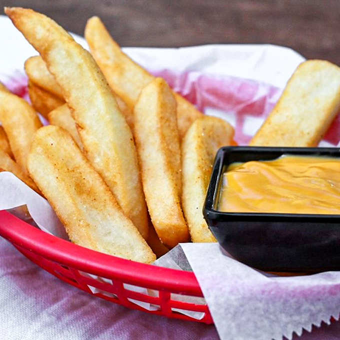 Golden, crispy fries with cheese sauce for dipping – proof that sometimes the simplest pleasures are worth crossing state lines for.