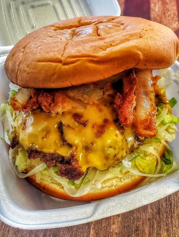 The cheeseburger that launched a thousand return visits—melty American cheese cascading down a perfectly grilled patty like a yellow waterfall of happiness.