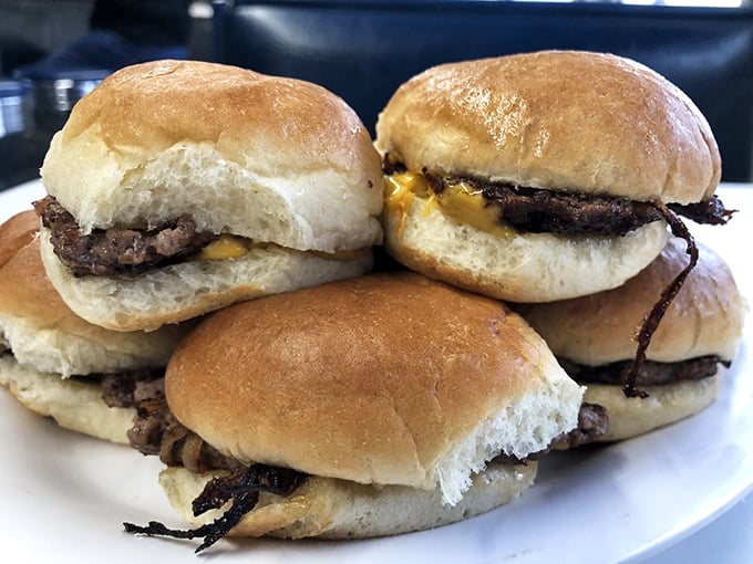 Sliders that don't need fancy toppings or pretentious names—just honest beef on pillowy buns that would make fast food chains weep with envy.