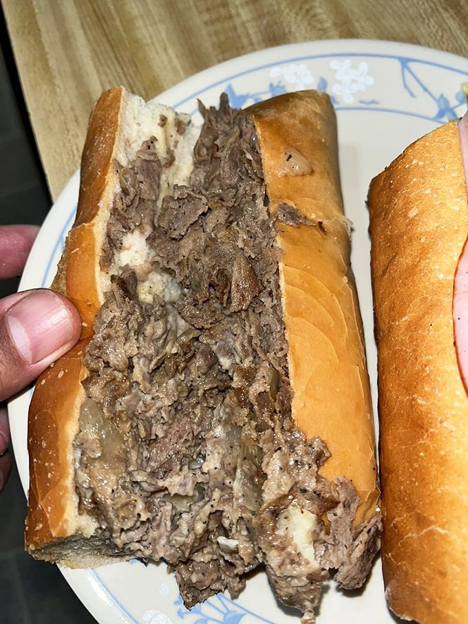 The cheesesteak – a glorious mess of thin-sliced beef and melted cheese packed into a crusty roll, no frills, all flavor.