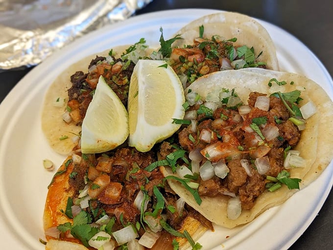 Chicharron tacos with lime wedges standing at attention – a perfect balance of crunch, chew, and zing that makes your taste buds stand up and salute.