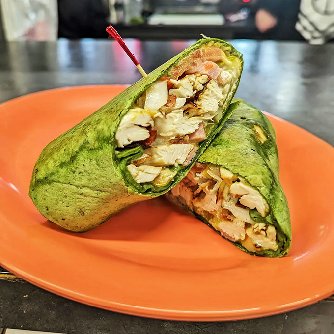 This wrap isn't just lunch—it's edible architecture. The spinach provides the color pop that Instagram filters wish they could replicate.