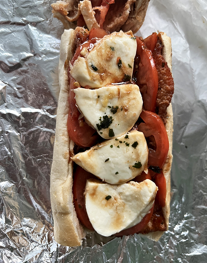 Fresh mozzarella and tomato – a romance for the ages. This chicken cutlet sandwich proves that sometimes the simplest combinations create the most passionate food affairs.