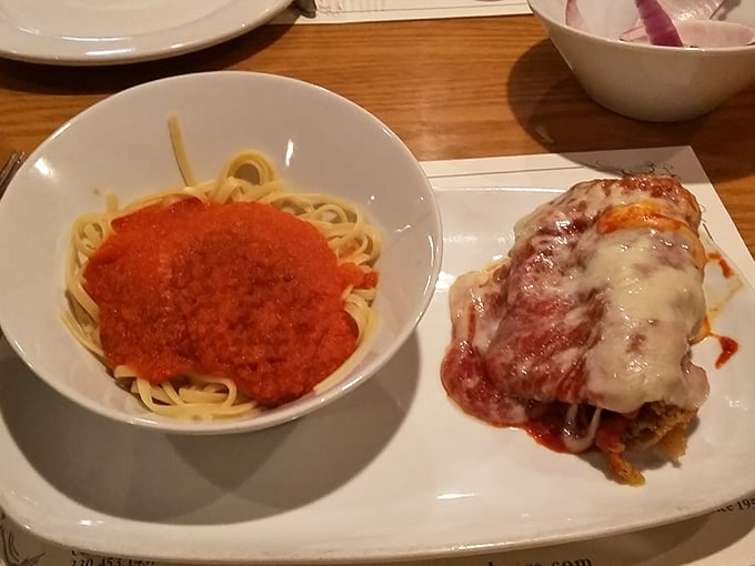 The star of the show: chicken parmesan served alongside spaghetti—a classic pairing executed with the confidence that comes from decades of perfecting a recipe.