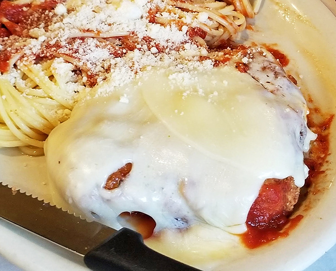 Chicken Parmesan that would make any Italian grandmother nod in approval – a melty cheese blanket covering seasoned perfection.
