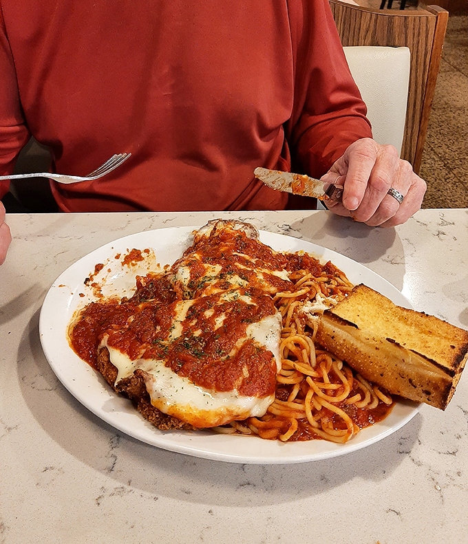 Chicken parmesan that doesn't just whisper "comfort food" – it belts it out like Pavarotti at his prime, complete with a perfect side of spaghetti.