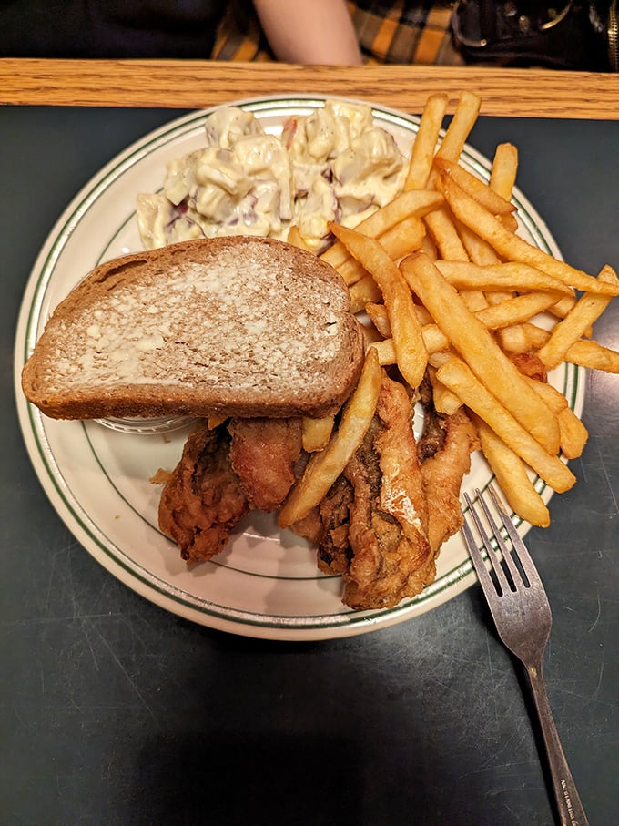 Comfort on a plate! Golden fries, creamy pasta salad, and what appears to be a classic chicken sandwich—the holy trinity of diner perfection.