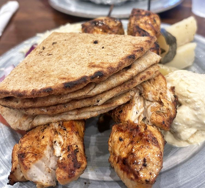 Perfectly charred chicken souvlaki with warm pita—proof that the simple things in life are often the most delicious.