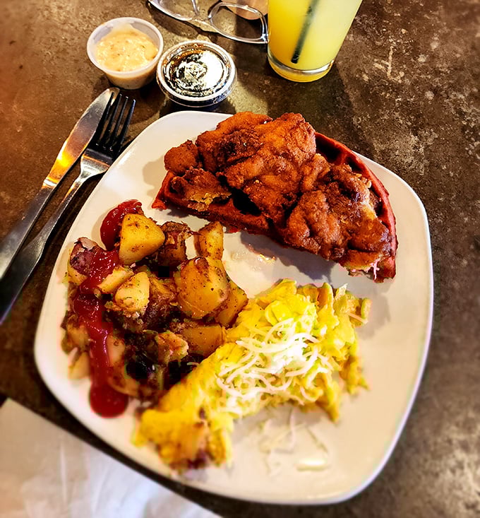 Southern comfort reimagined: crispy fried chicken perched atop a red velvet waffle with potatoes and eggs. Breakfast or lunch? Yes, please.