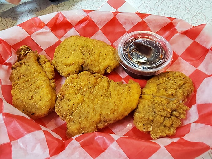 Chicken tenders that actually deserve the name—crispy armor protecting juicy meat that puts fast food imposters to shame. The dipping sauce is just a bonus.