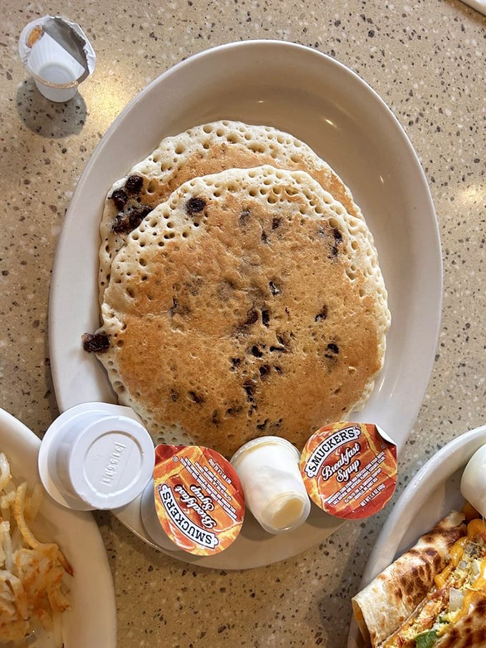 Chocolate chip pancakes so perfectly golden they deserve their own Instagram account. Smuckers on the side—because some traditions are sacred.