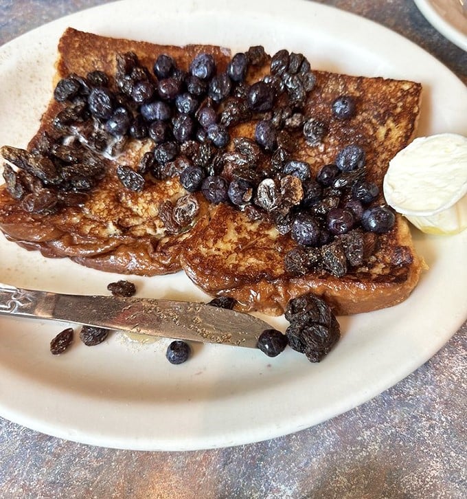 Blueberry French toast that doesn't just feed you – it hugs you from the inside, with plump berries creating little pockets of warm, sweet joy in every bite.