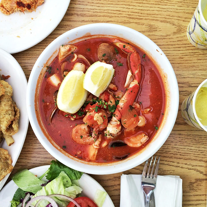 The cioppino – a tomato-based seafood symphony where every spoonful delivers a different ocean treasure. This isn't soup; it's an underwater expedition.