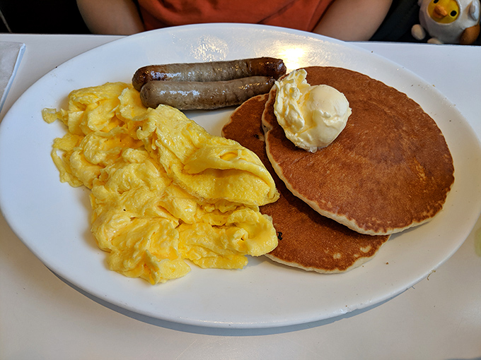 The breakfast that launched a thousand Saturday mornings. Fluffy pancakes, scrambled eggs, and sausage links—the holy trinity of diner breakfasts done right.