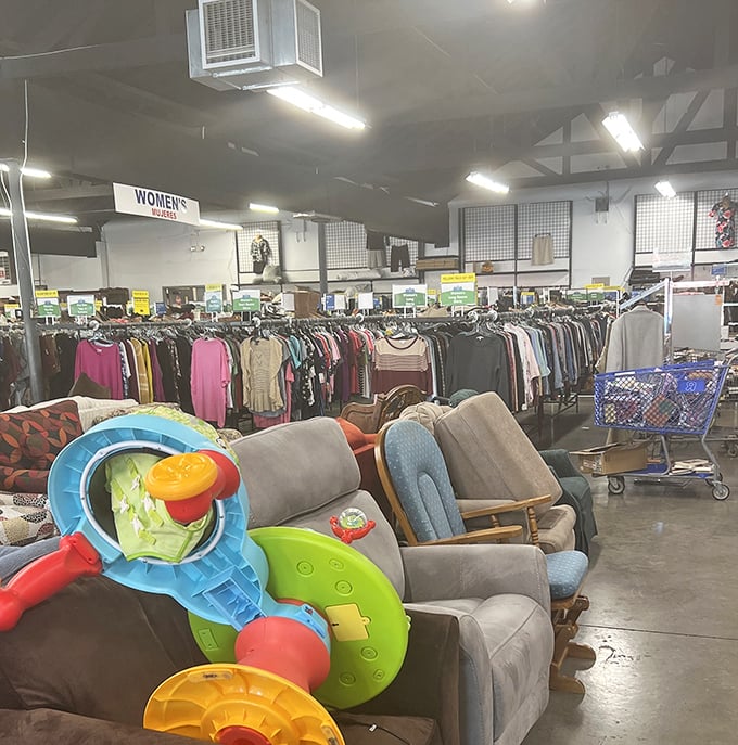 The clothing racks form a textile rainbow, where yesterday's fashion statements await their second chance to make a first impression.