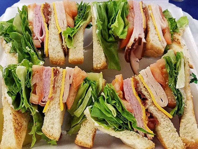 The architectural marvel that is a proper club sandwich—three stories of deliciousness held together by those colorful toothpick pillars.