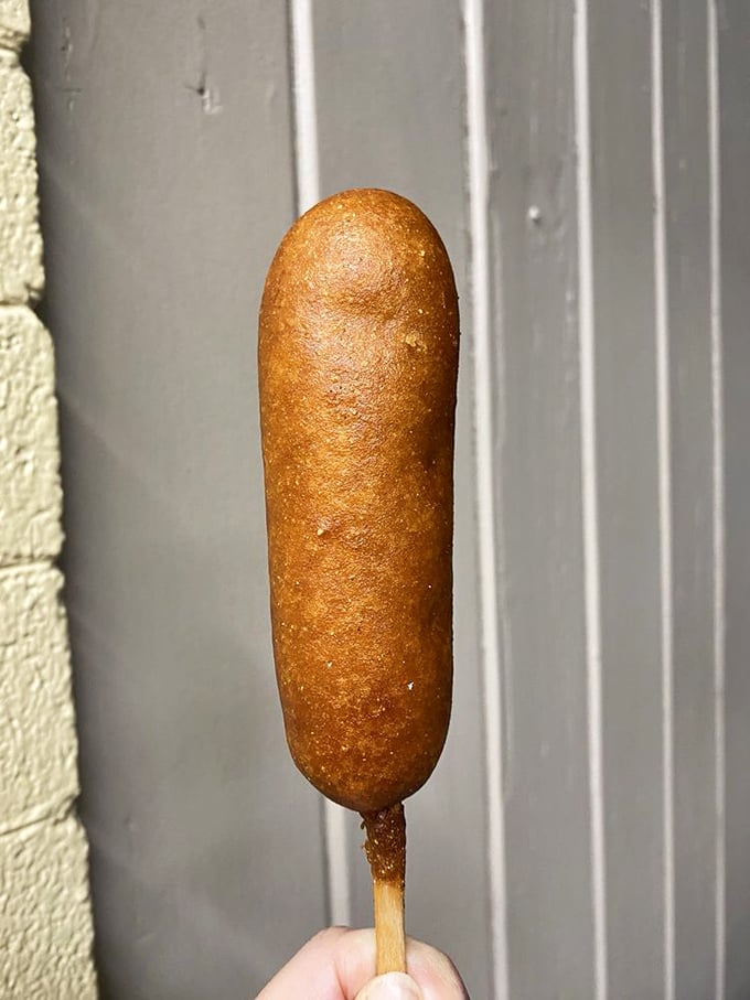 The corn dog—America's contribution to food-on-a-stick culture—elevated to an art form with that perfect golden-brown crust.