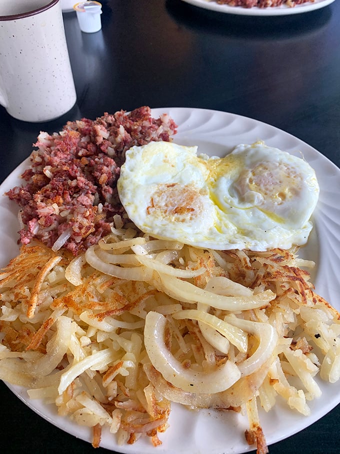 Corned beef hash with eggs and hash browns—the breakfast equivalent of hitting the jackpot on a slot machine of flavor.