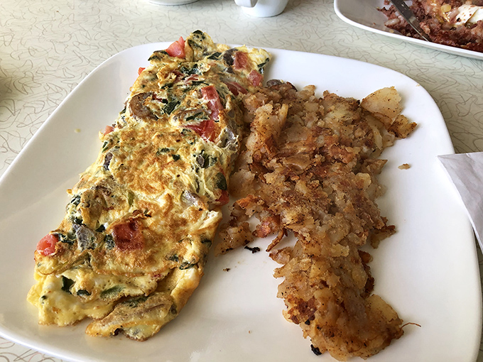 A vegetable omelet that actually delivers on its promise—packed with fresh ingredients and paired with home fries that deserve their own fan club.