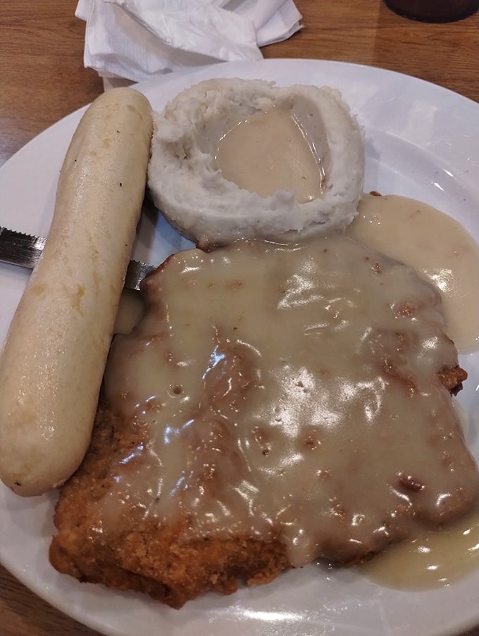 Country fried steak swimming in gravy with a side of mashed potatoes—comfort food that hugs your soul while gleefully ignoring your arteries.