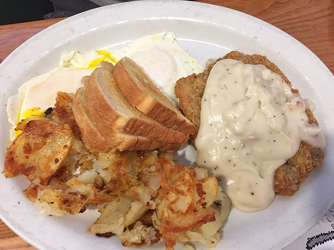 The legendary country fried steak, draped in velvety gravy alongside golden hash browns and eggs. This isn't breakfast—it's an event.