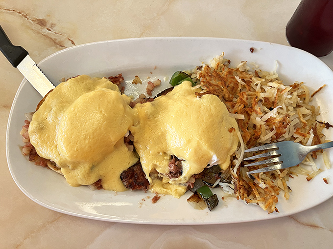 Country Benedict: where hollandaise dreams come true. Those crispy potatoes aren't just sharing the plate—they're fighting for the spotlight.
