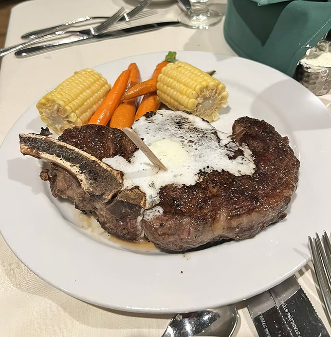The cowboy-cut ribeye arrives with corn on the cob and carrots, creating the perfect color palette of a California sunset on your plate.