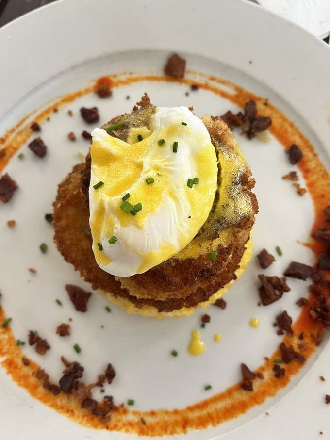 This isn't just a crab cake—it's a masterpiece with a poached egg crown. The sauce creates a royal moat worthy of this culinary castle. 
