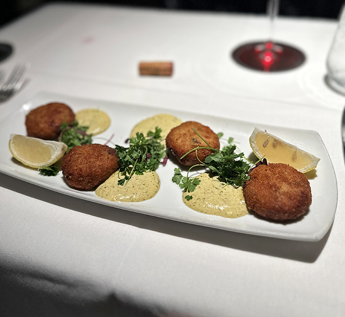 Golden-brown crab cakes that are actually crab (imagine that!)—perched atop creamy sauce with fresh herbs that make seafood lovers weak at the knees.
