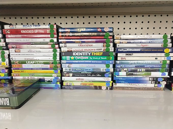 Hollywood's greatest hits, neatly organized with color-coded stickers. "Identity Thief" seems ironically placed in this secondhand paradise.