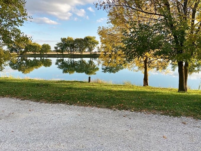 Mirror-like waters reflect golden trees at this serene park – proof that sometimes the most memorable vacation moments come without admission fees.