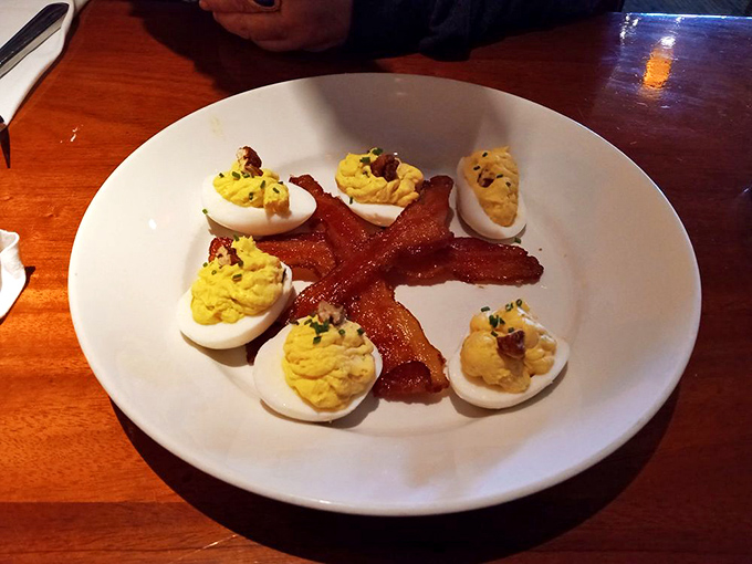 Deviled eggs arranged like a delicious flower, with bacon as the centerpiece – breakfast's greatest hits remixed for dinner.