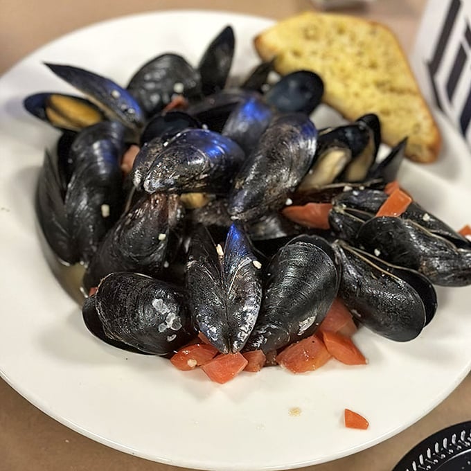 These mussels have clearly been hanging out with some tasty friends—garlic, tomatoes, and herbs that make the shells perfect sauce-dippers.