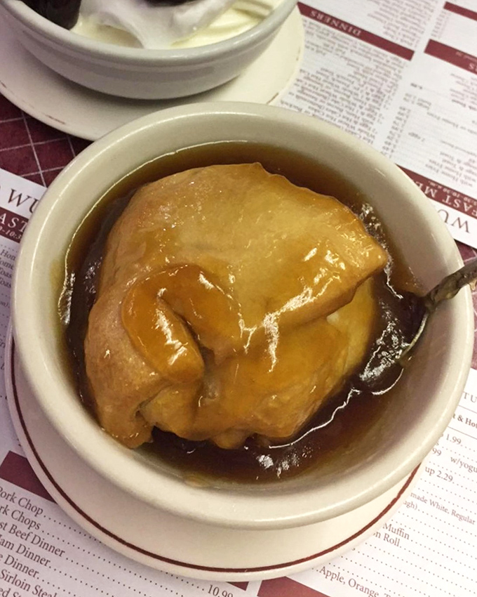 A dumpling floating in broth like a life preserver in a sea of flavor. Comfort food that doesn't need a therapist's couch.