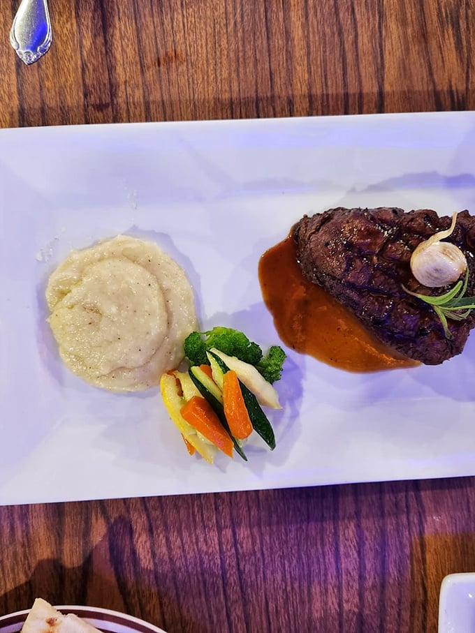 Filet mignon presented with artistic flair – a masterpiece of beef alongside creamy mashed potatoes and colorful vegetables. Meat as fine art.