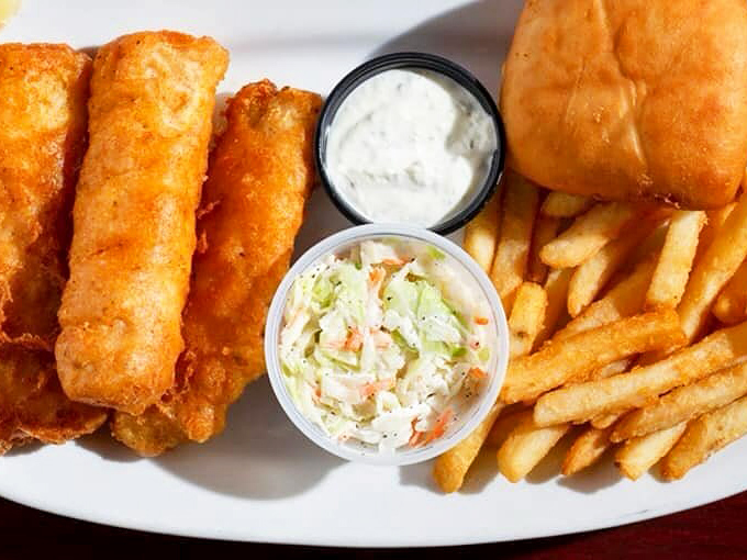 These fish and chips aren't just a meal—they're an edible hug. The coleslaw adds that tangy crunch that keeps you coming back for more.