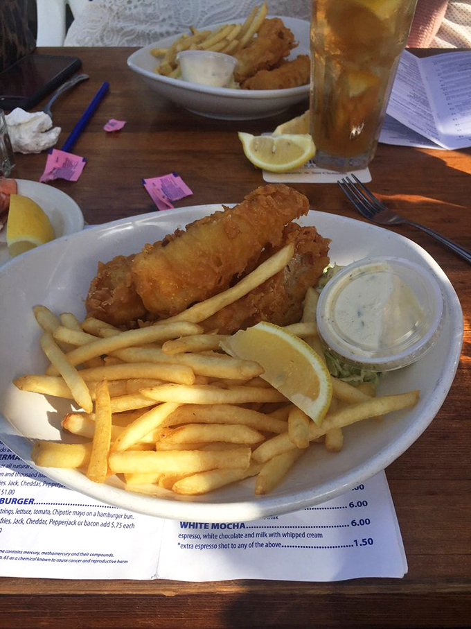 Fish and chips that would make a British pub jealous. Crispy, golden batter protecting flaky white fish—a beach classic elevated to art form.
