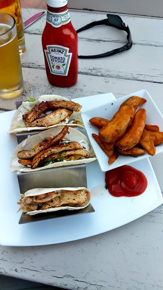 These fish tacos don't need a passport to deliver authentic flavor—just perfectly seasoned fish, fresh toppings, and a side of golden fries for good measure.