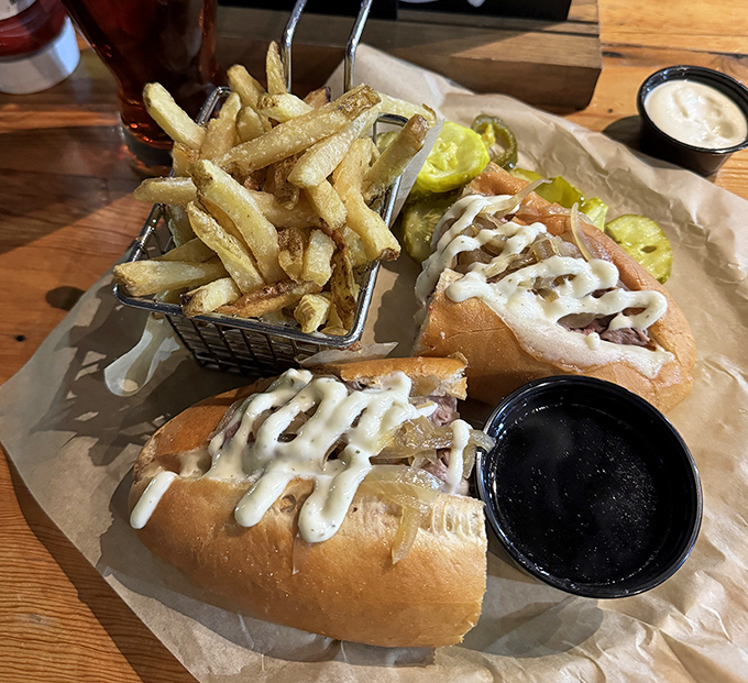 The French Dip sandwich—where thinly sliced beef meets its soulmate in au jus. Those fries aren't just a side; they're co-stars.