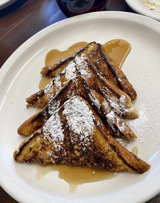 French toast that's actually been introduced to France – golden, crispy edges with a tender center and enough powdered sugar to make your dentist wince.