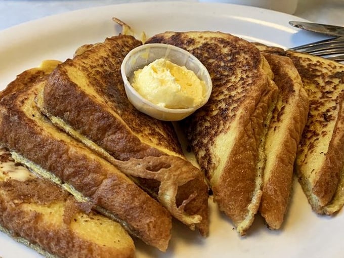 French toast golden enough to make King Midas jealous. That butter cup isn't a suggestion – it's an essential part of the experience.