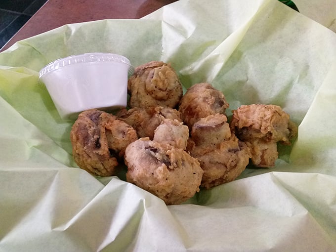 Fried mushrooms that look like they've been dipped in liquid gold, offering that perfect crisp-then-juicy bite that makes you forget mushrooms grow in the dark.