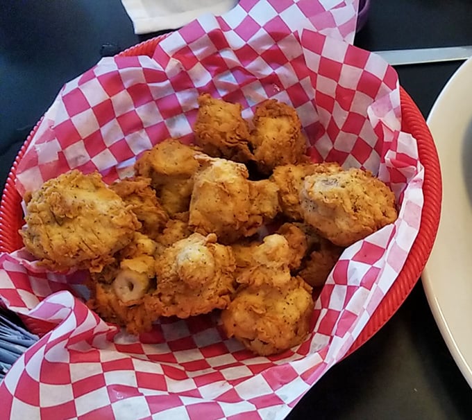 Golden-fried mushrooms nestled in a red checkered basket—crispy outside, juicy inside, and utterly impossible to stop eating.