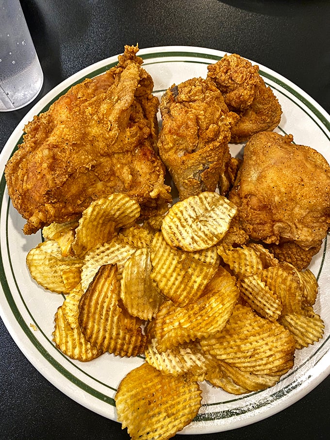 Crispy fried chicken with ridges and valleys of golden crust that crackle with each bite, served with chips that never stood a chance.