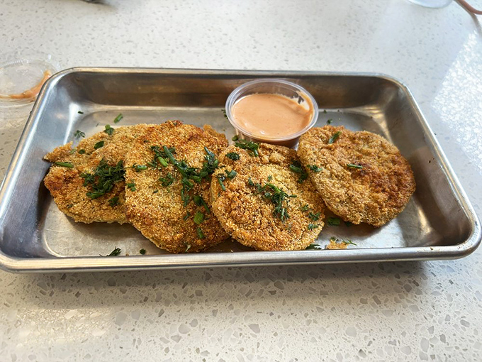 Fried green tomatoes with a side of comeback sauce—proof that unripe fruit can become something transcendent when treated with respect and hot oil.