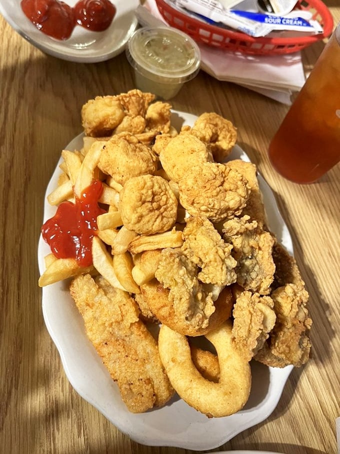 A seafood medley that puts ordinary platters to shame—crispy rings, tender nuggets, and fries creating the holy trinity of fried goodness.