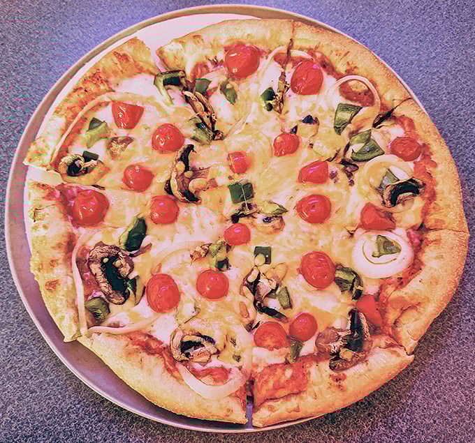 Garden pizza that actually tastes like a garden—bright cherry tomatoes, fresh green peppers, and mushrooms arranged not by accident but with purpose and respect.