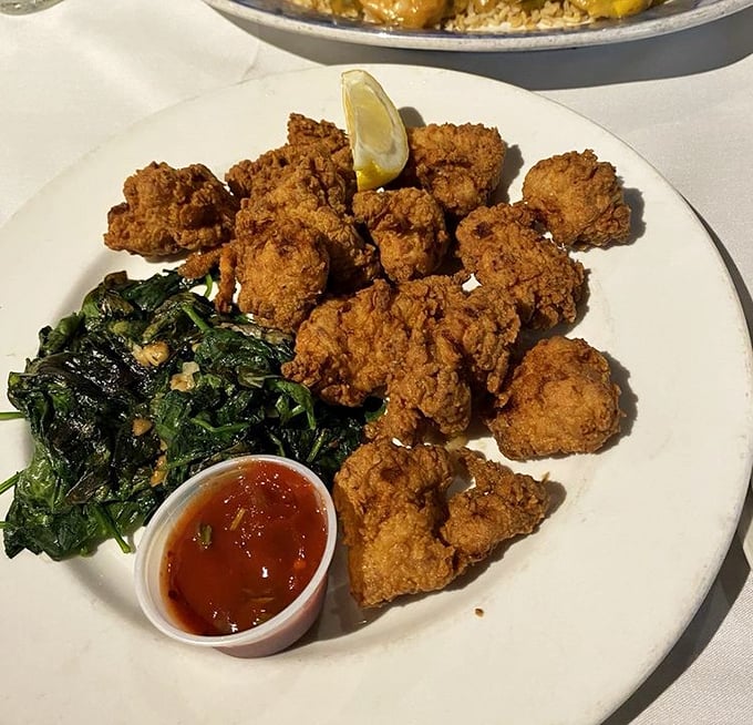 Crispy gator tail: Florida's answer to popcorn chicken, but with bragging rights. That spinach side isn't just healthy—it's actually delicious.